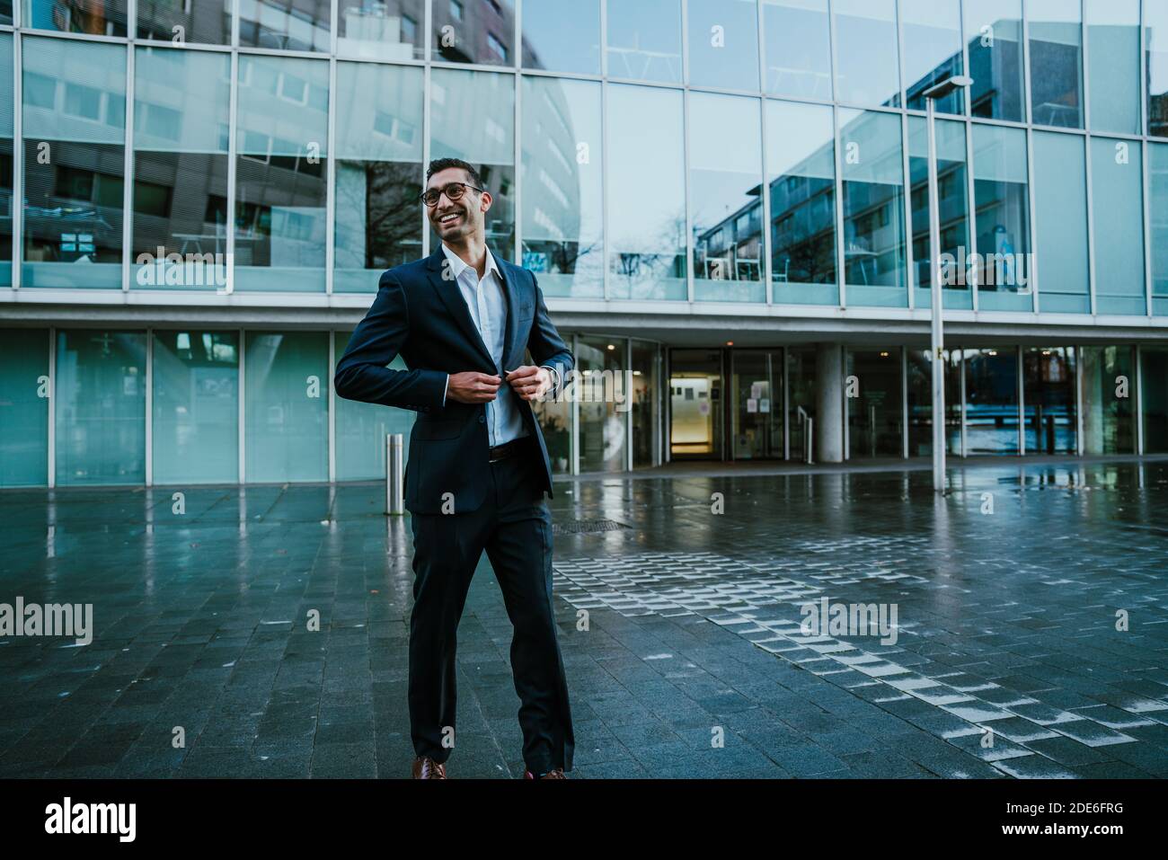 Caucasian businessman standing outside banking office dressed smartly ...