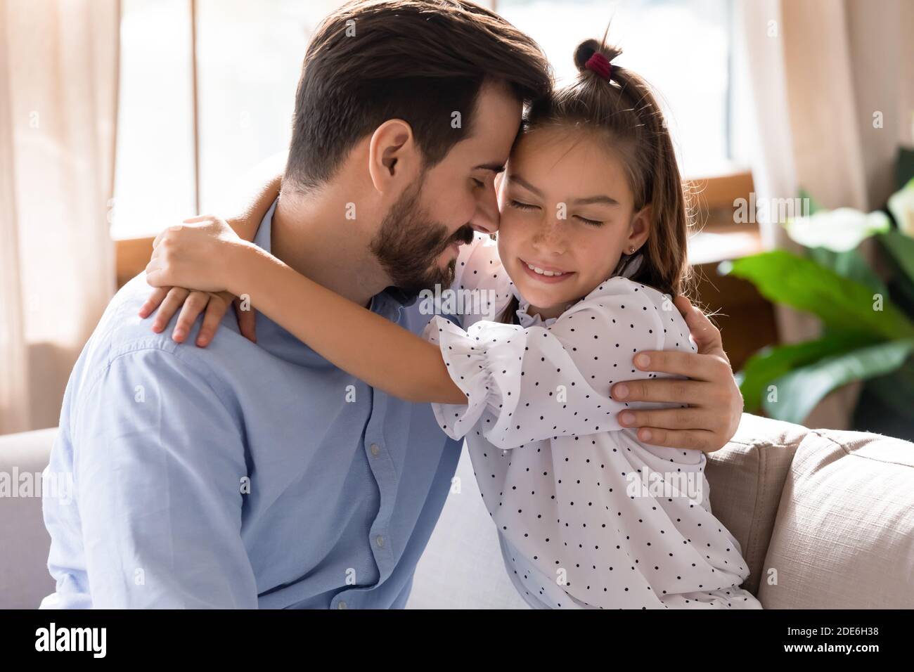Young dad and little daughter hug enjoying tender moment Stock Photo ...