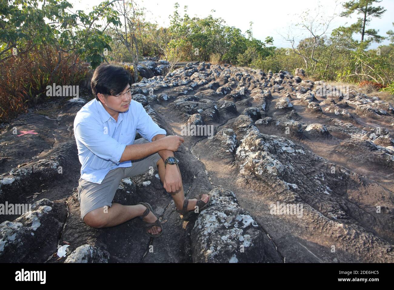 man sitting on stone Stock Photo - Alamy