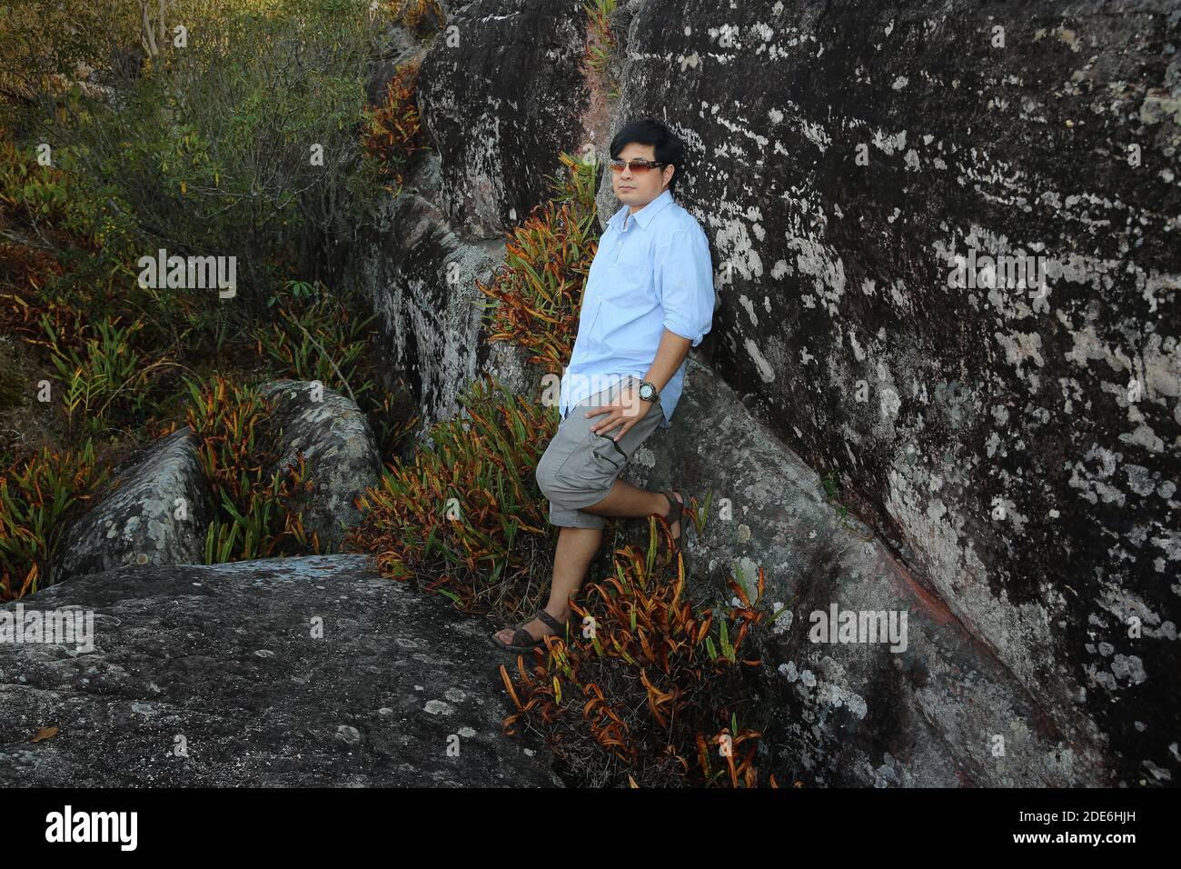 Guy sitting on edge stone hi-res stock photography and images - Alamy