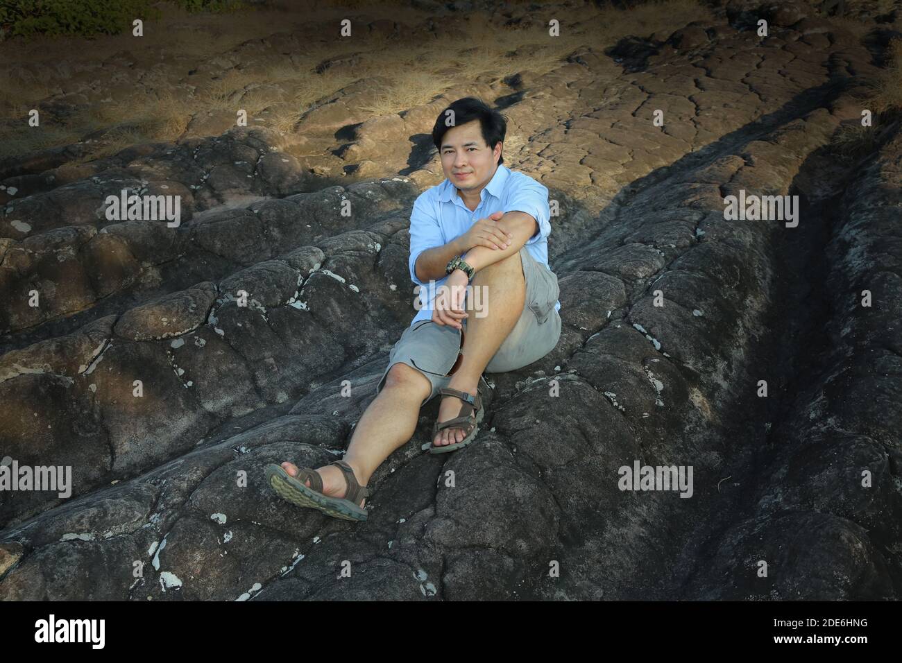 Guy sitting on edge stone hi-res stock photography and images - Alamy