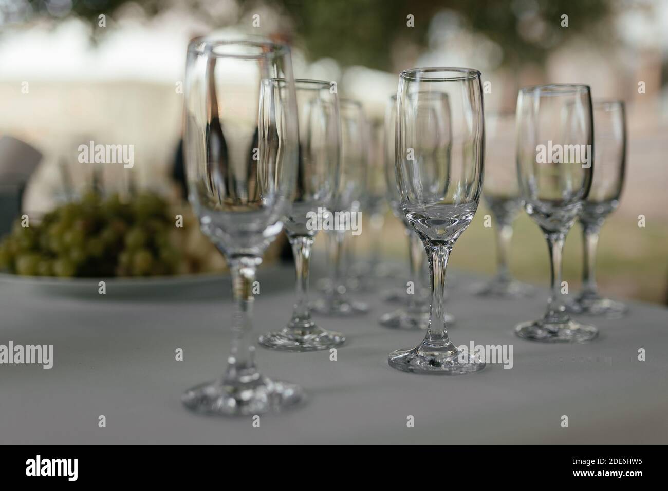 Empty champagne glasses at the white table with the place for your text ...