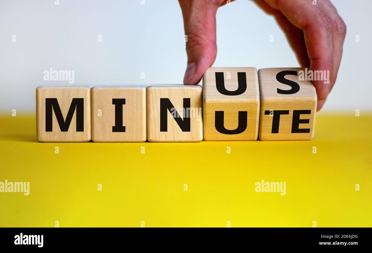 Minus minute. Male hand turns wooden cubes and changes the word 'minute ...
