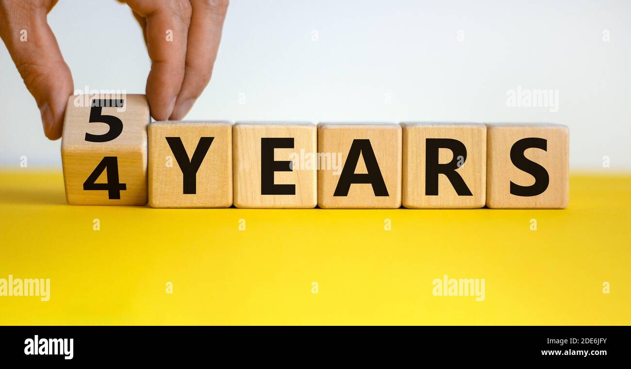 5th anniversary. Male hand turns cubes and changes the expression '4 ...