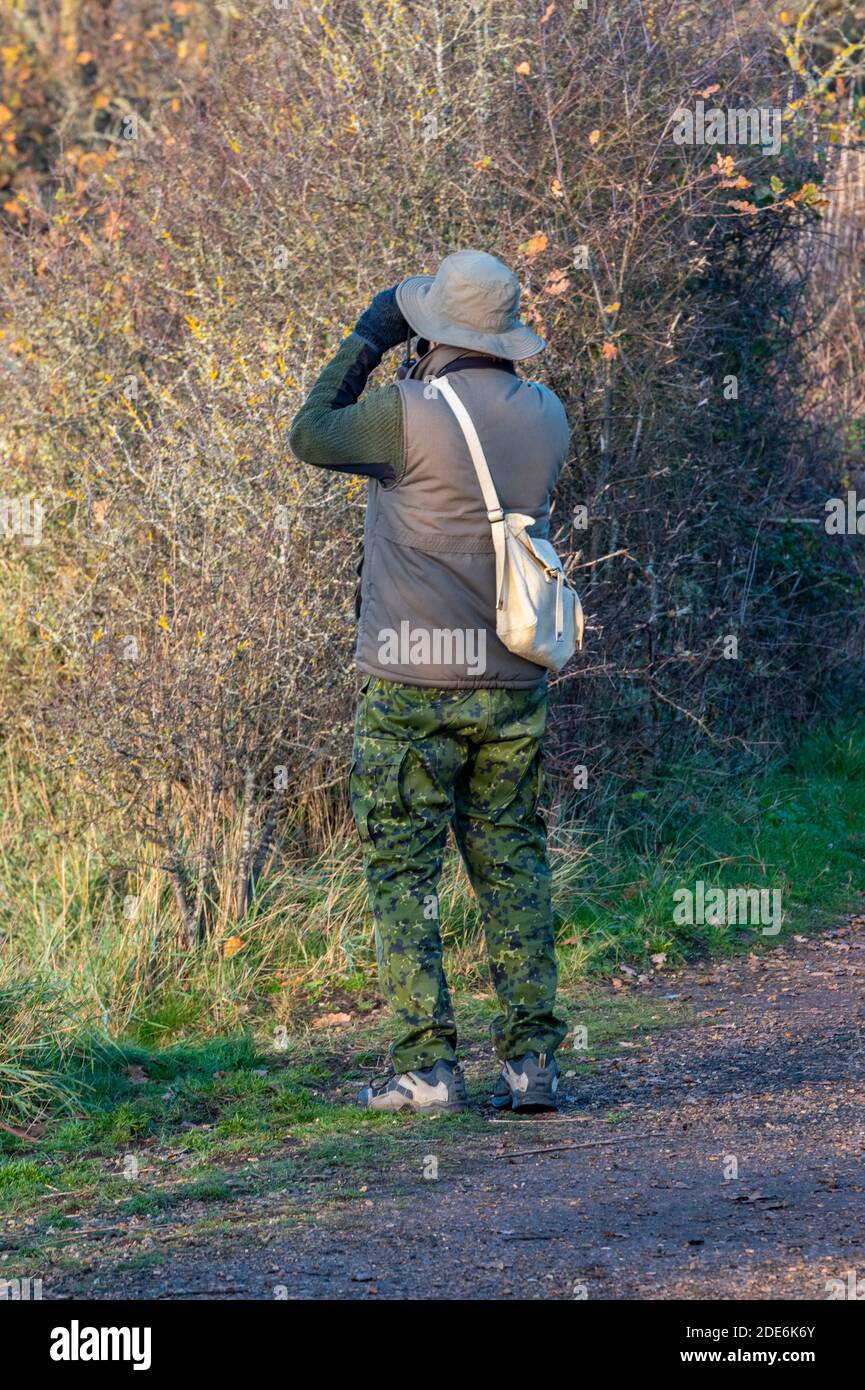 Man watching birds through binoculars hi-res stock photography and ...