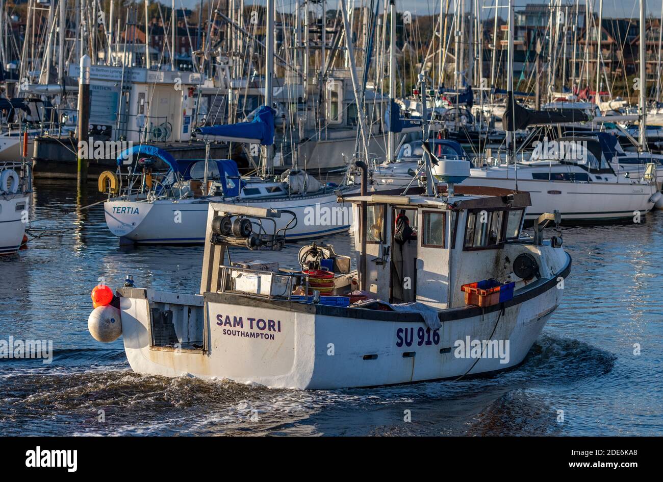 a small inshore fishing boat trawler entering the port of lymington in ...