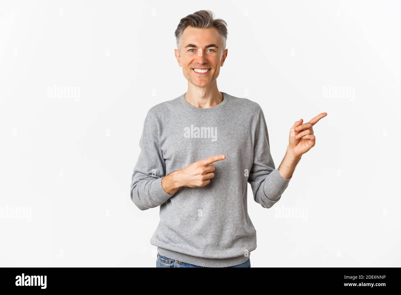 Image of handsome middle-aged man showing something on copy space ...