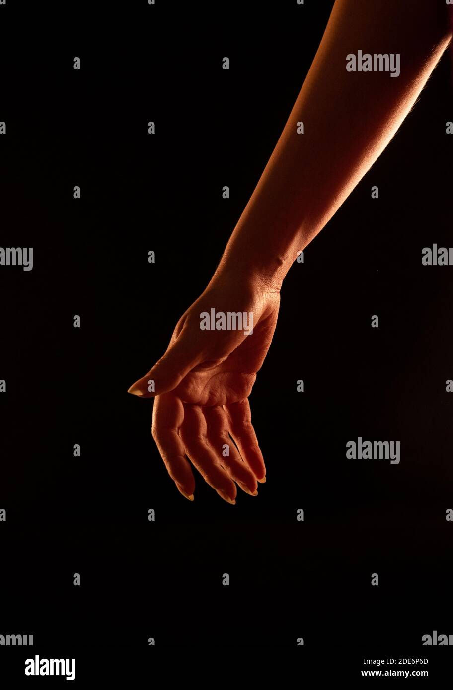 Beautiful Woman's Hand in Rim Light - Relaxed Stock Photo - Alamy