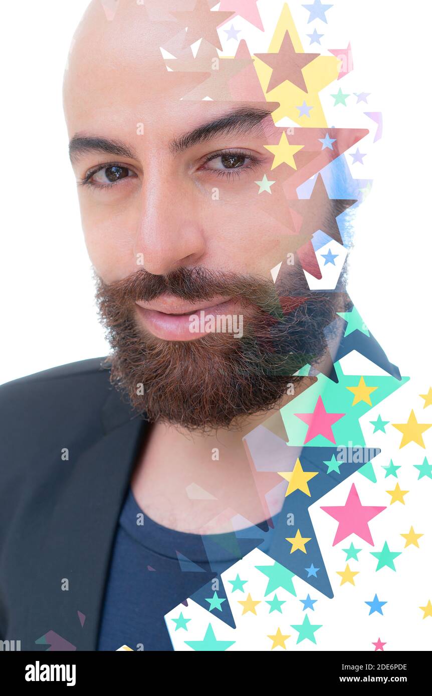 A bearded bold man in a black jacket with a sly smile looking into the ...