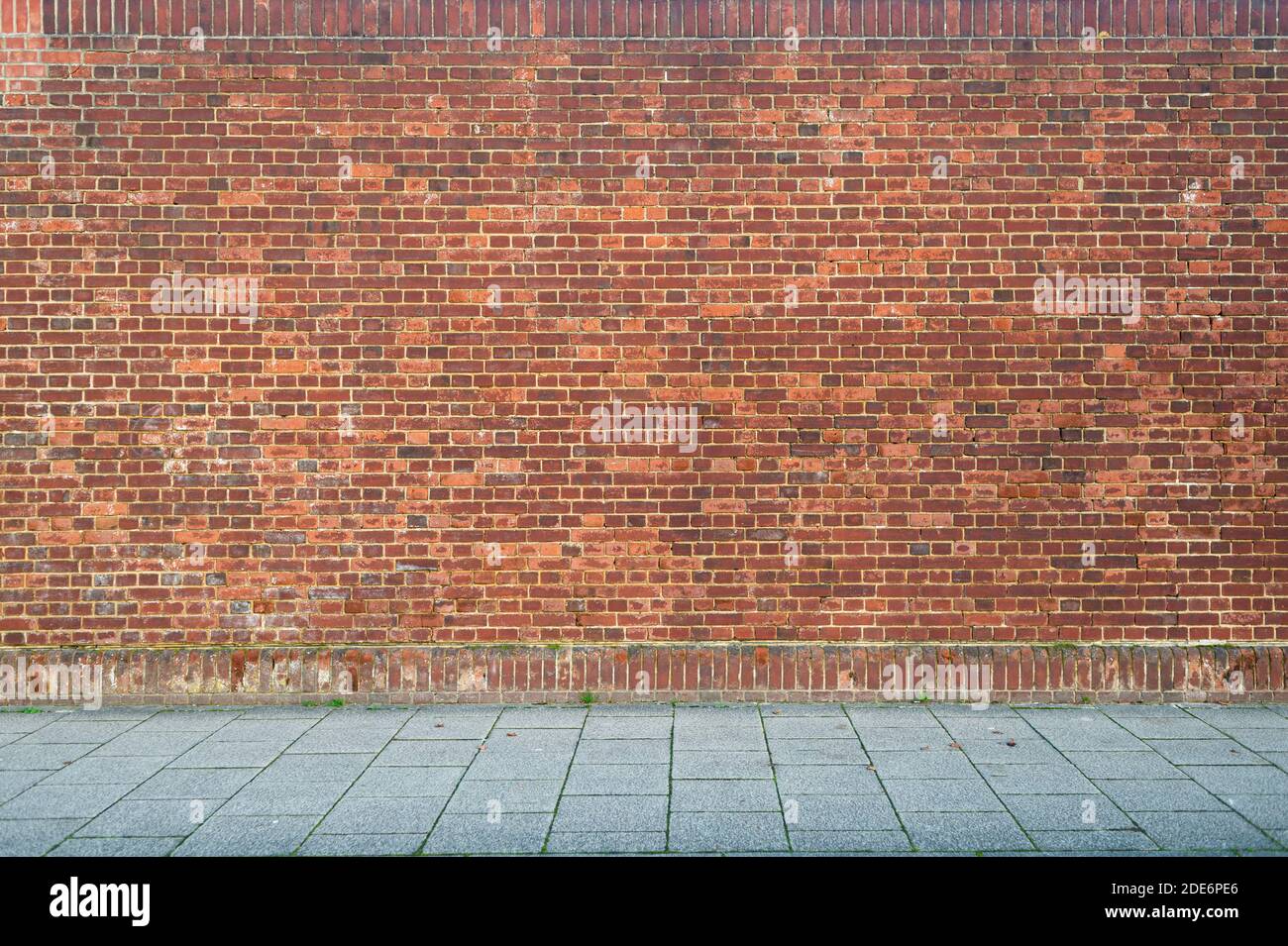 Brickwall background with sidewalk Stock Photo - Alamy