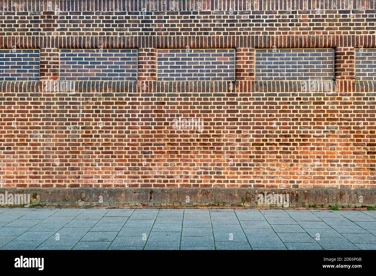 Brickwall background with sidewalk Stock Photo - Alamy