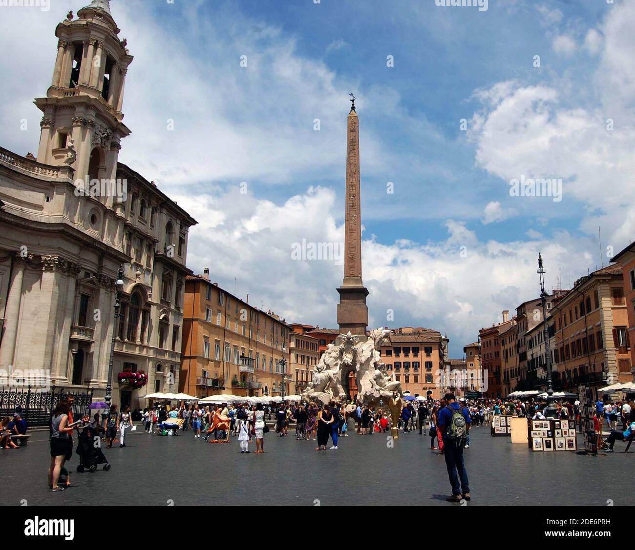 A busy market in the Piazza Navona in Rome, Italy behind which, in the ...