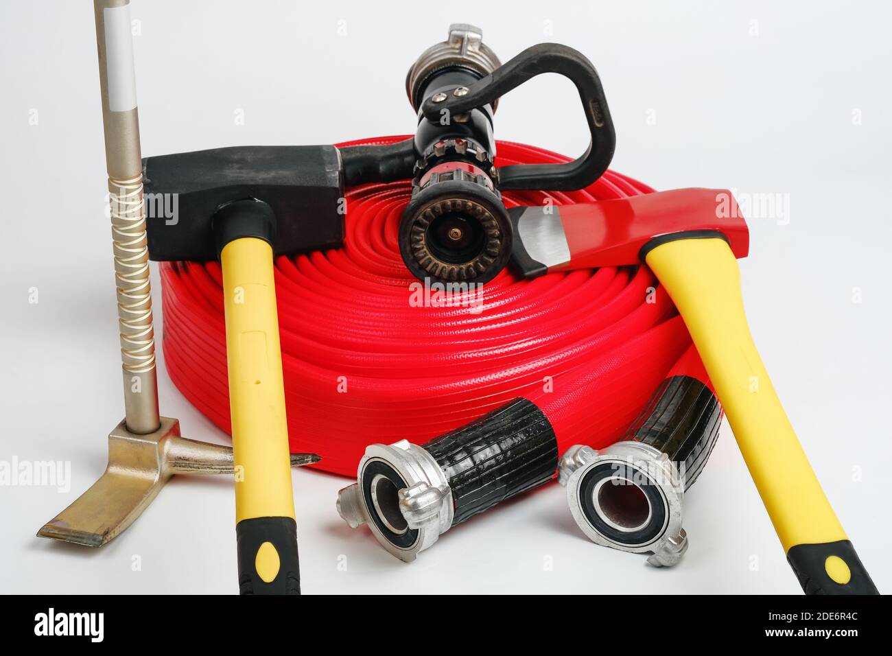 Fire hose, hooligan pinch-bar, yellow sledgehammer, axe from fireman's ...