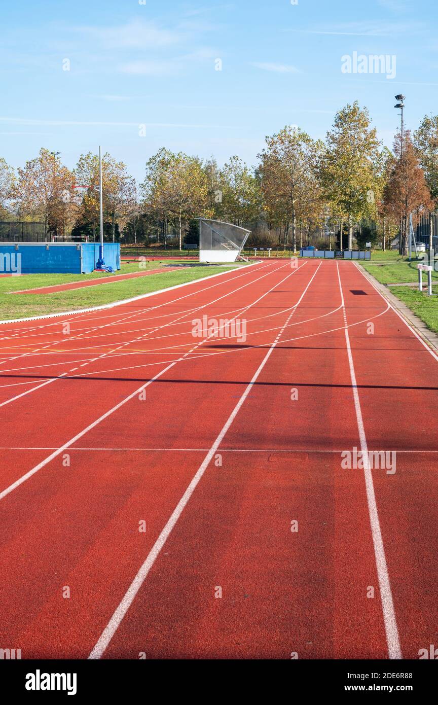 Empry red running lane on outdoor school stadium Stock Photo - Alamy