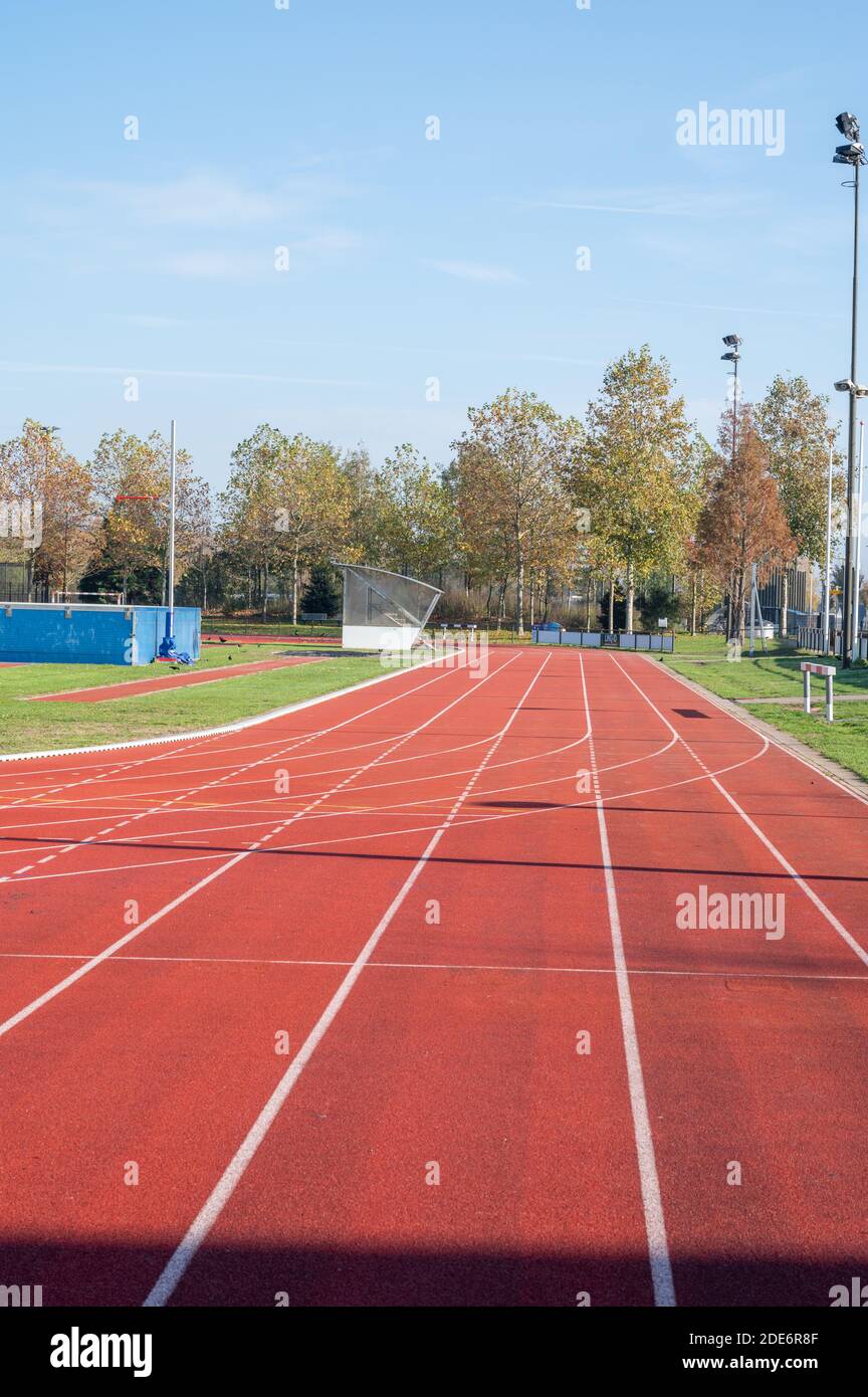 Empry red running lane on outdoor school stadium Stock Photo - Alamy