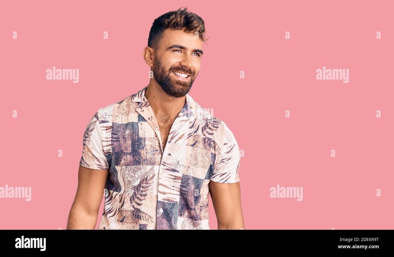 Young hispanic man wearing summer clothes looking away to side with ...