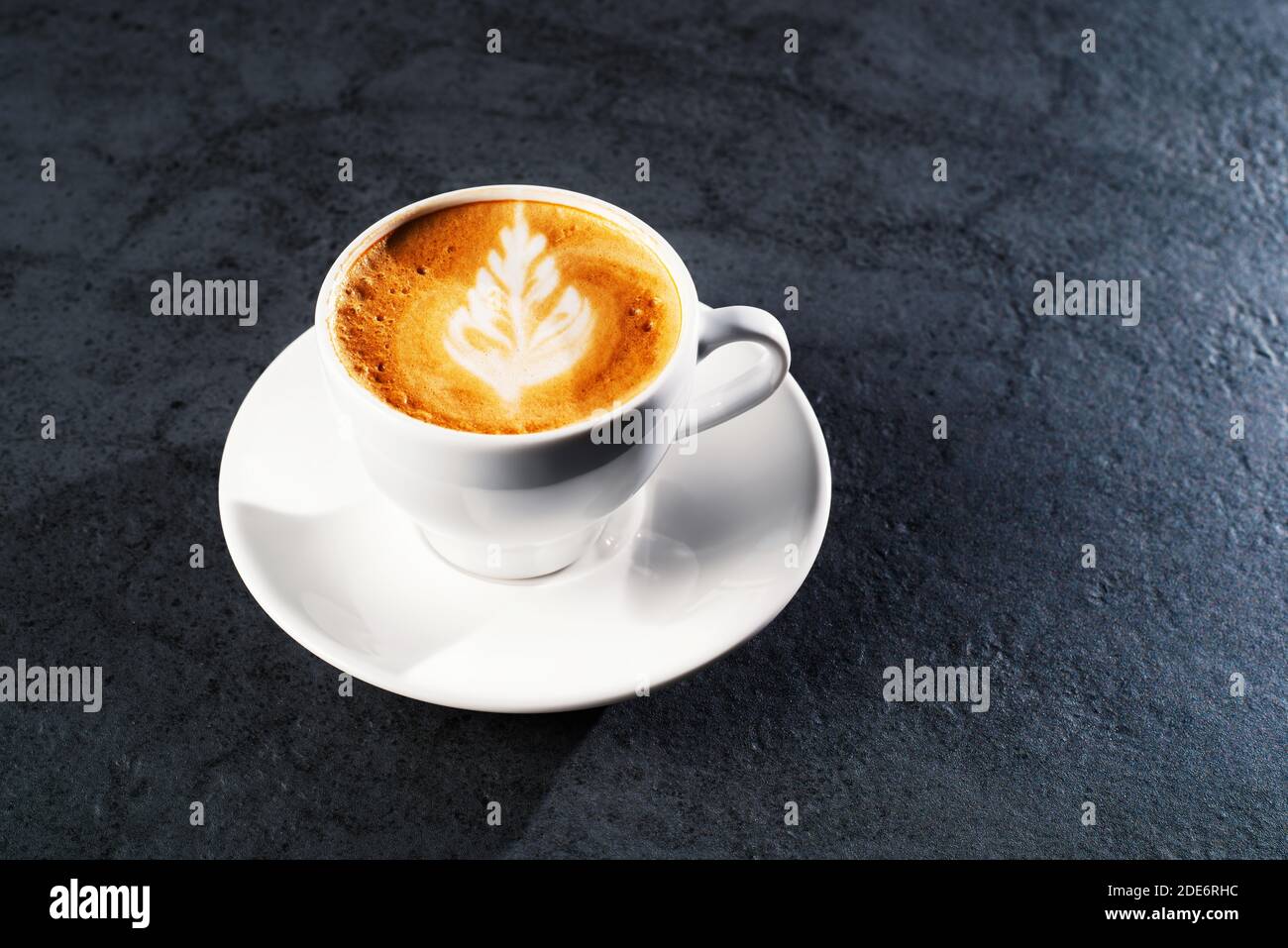 Cup of cappuccino on a wooden table in a coffee shop, side view ...