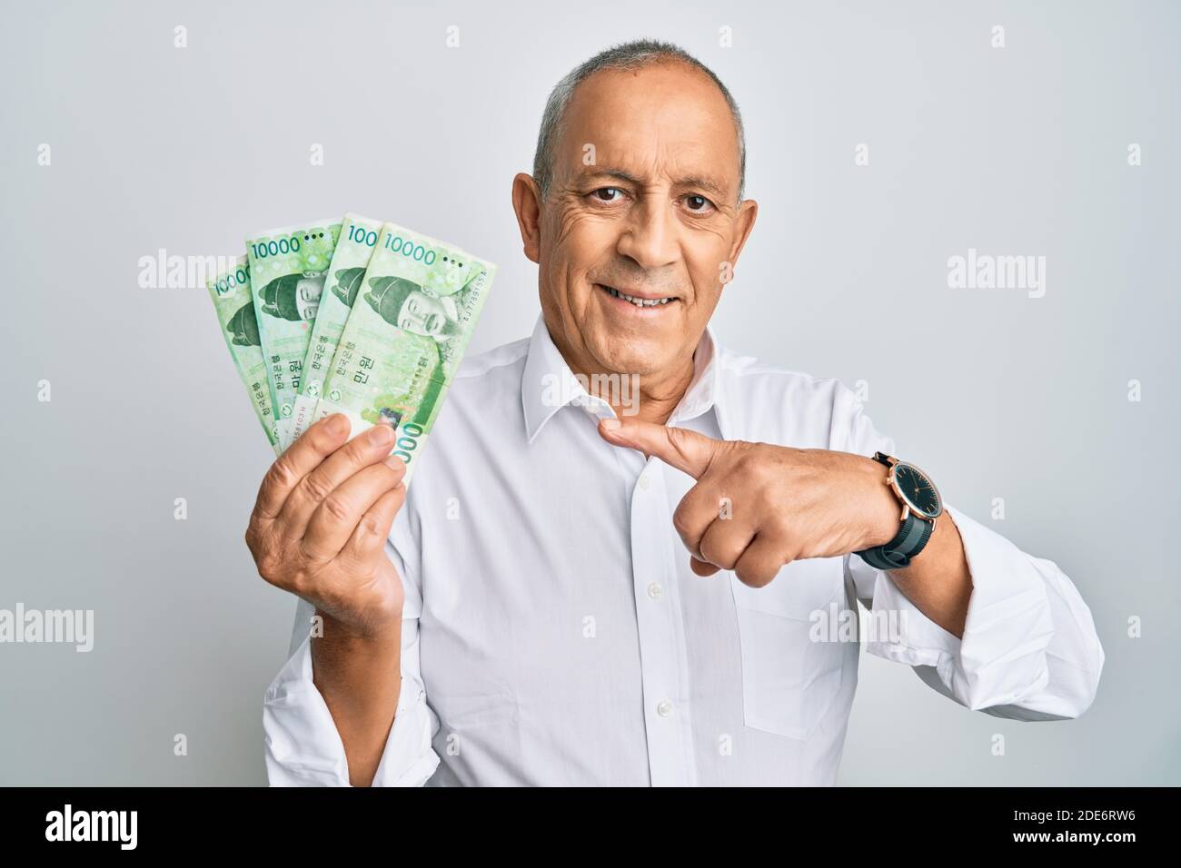 Handsome senior man holding 10000 south korean won banknotes smiling ...