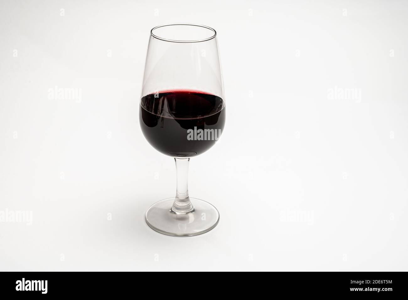 Glass of vintage ruby port wine isolated on white background close up ...