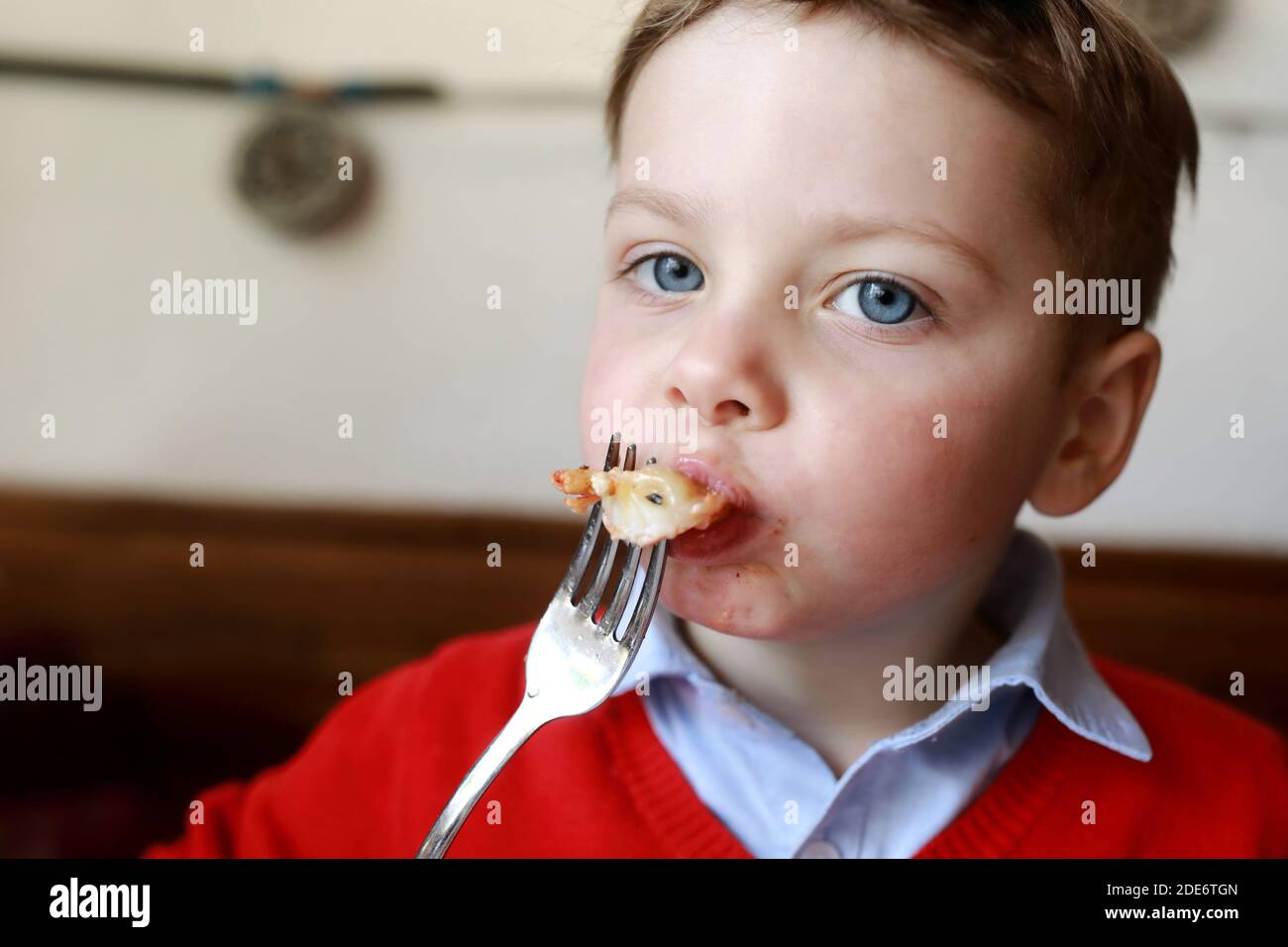 Hungry boy has shrimp in the restaurant Stock Photo - Alamy