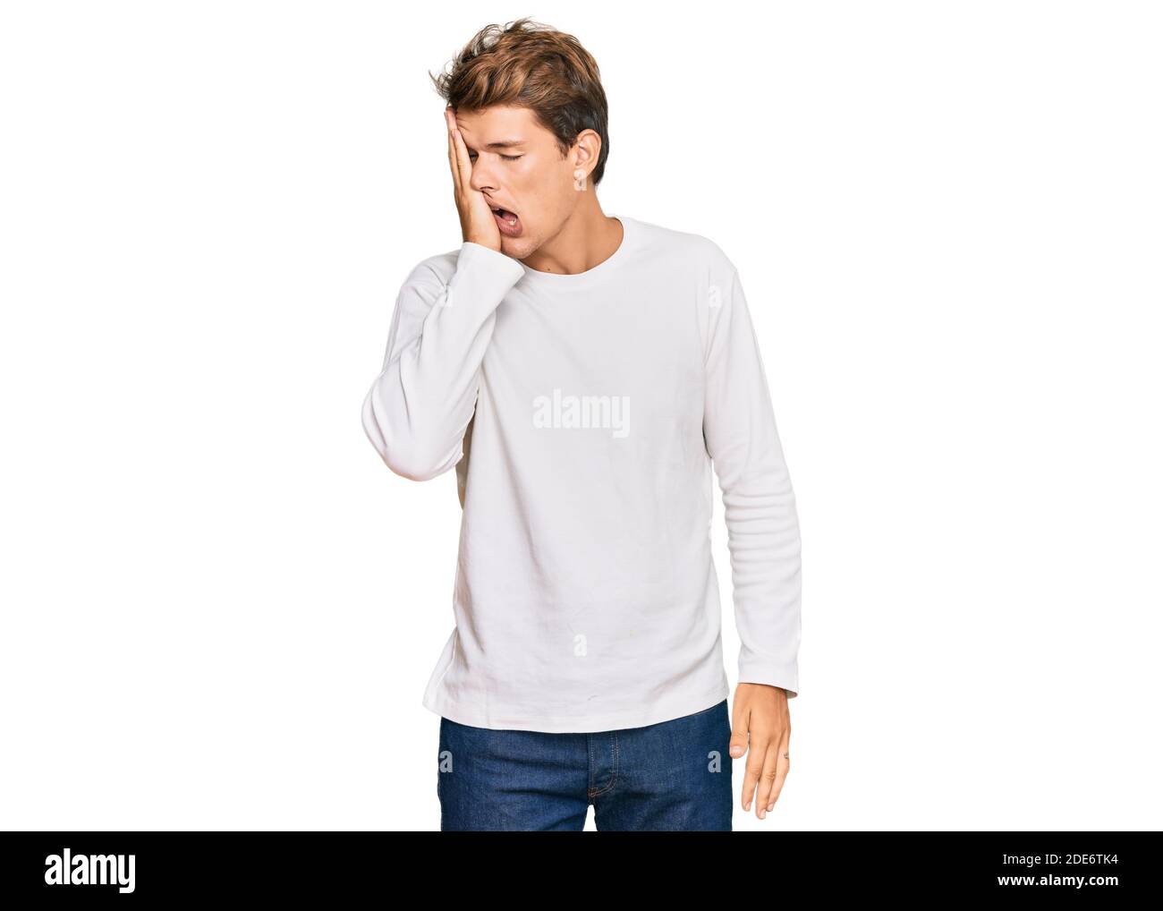 Handsome caucasian man wearing casual white sweater yawning tired ...