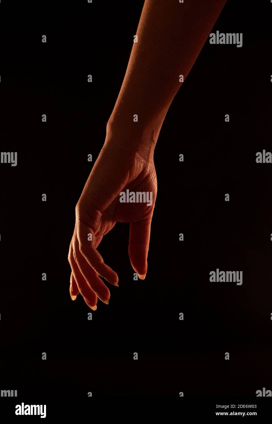 Beautiful Woman's Hand in Rim Light - Relaxed Stock Photo - Alamy