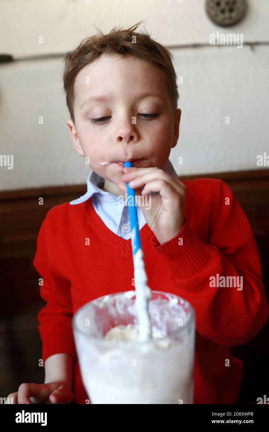 Boy in cafe drinking milkshake hi-res stock photography and images - Alamy