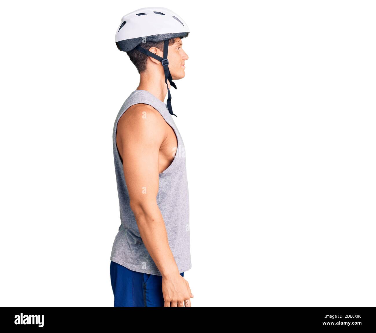 Young handsome man wearing bike helmet looking to side, relax profile ...