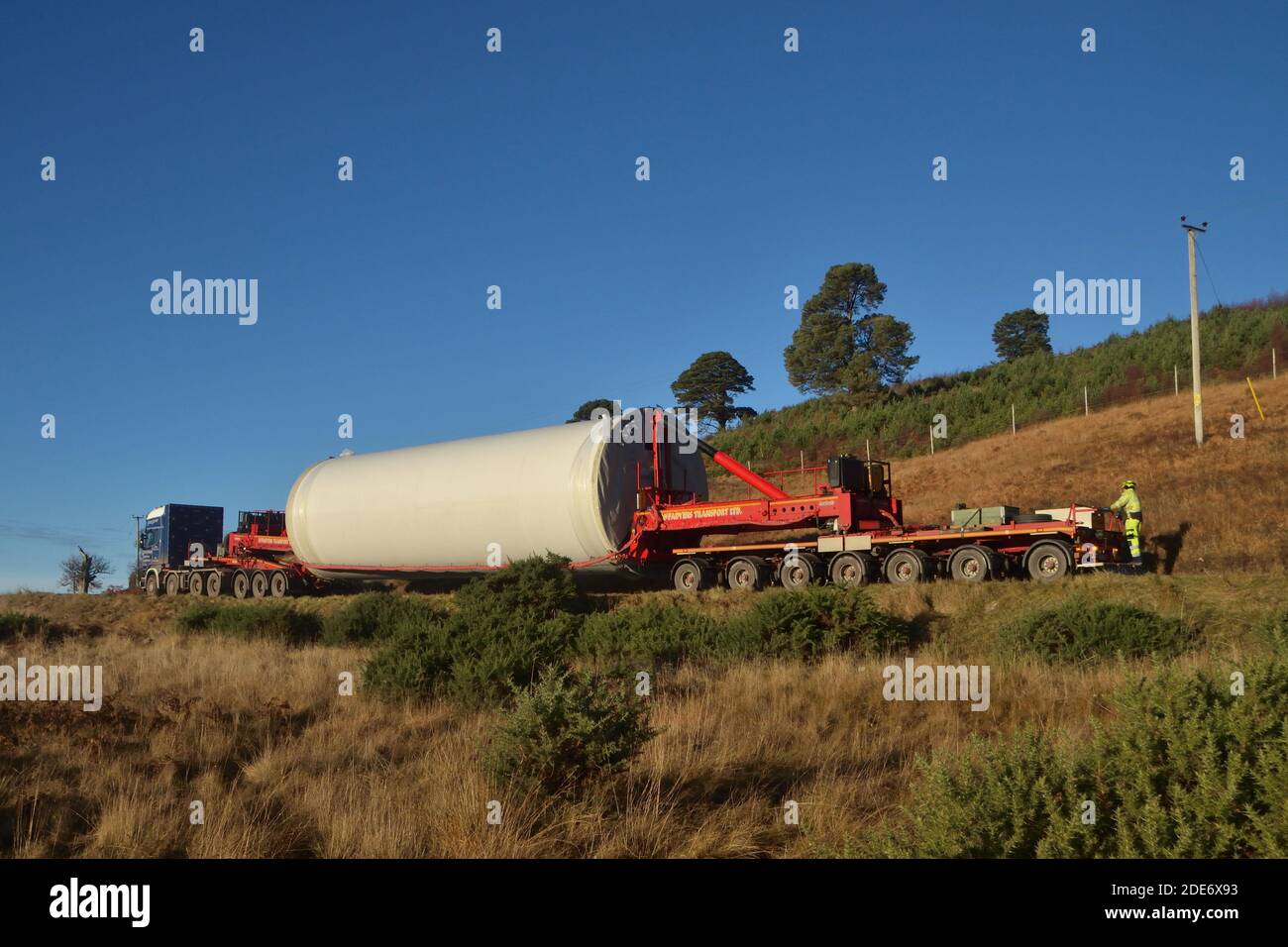 A specially adapted lorry carrying a large component of a wind turbine ...