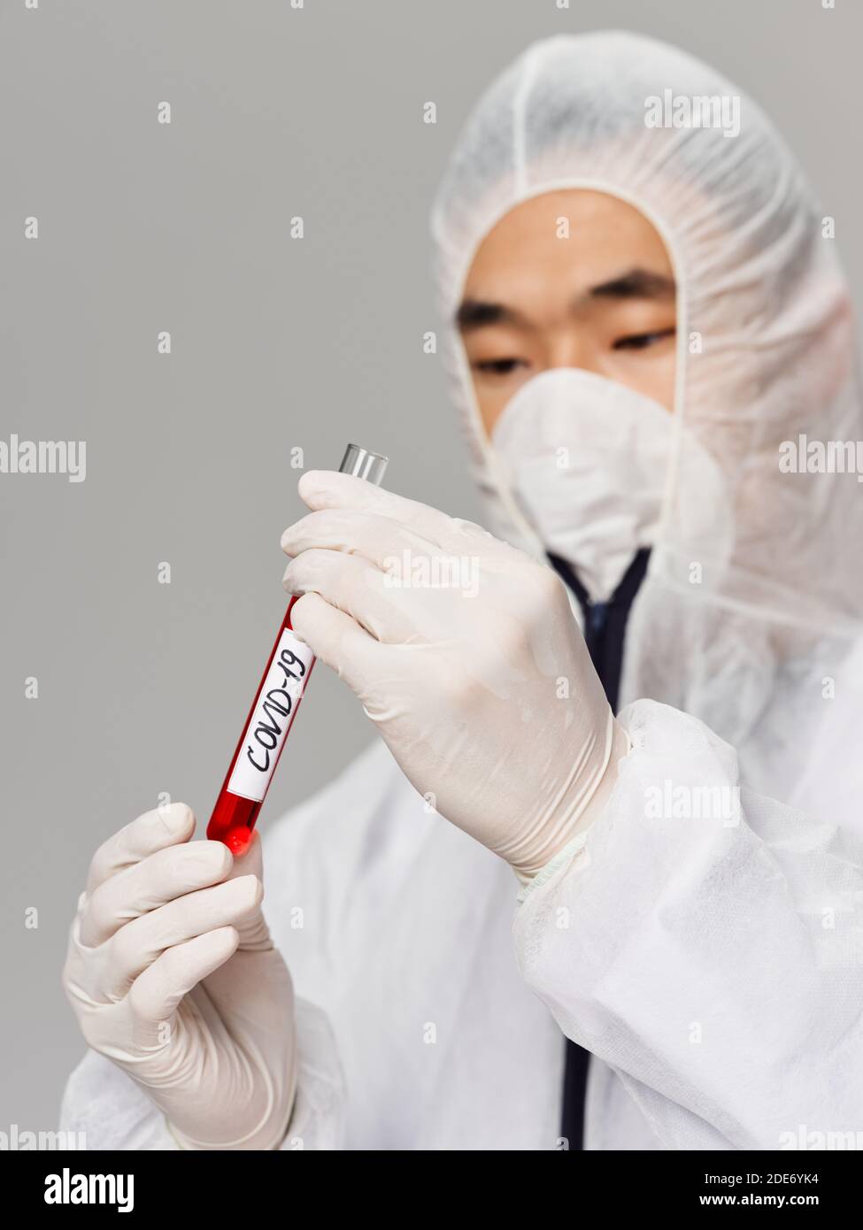 Asian male protective mask analyzes diagnostics treatment research Stock Photo - Alamy