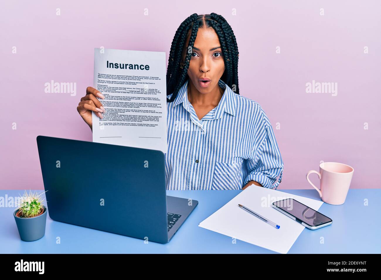 Beautiful hispanic woman at the office showing insurance document ...