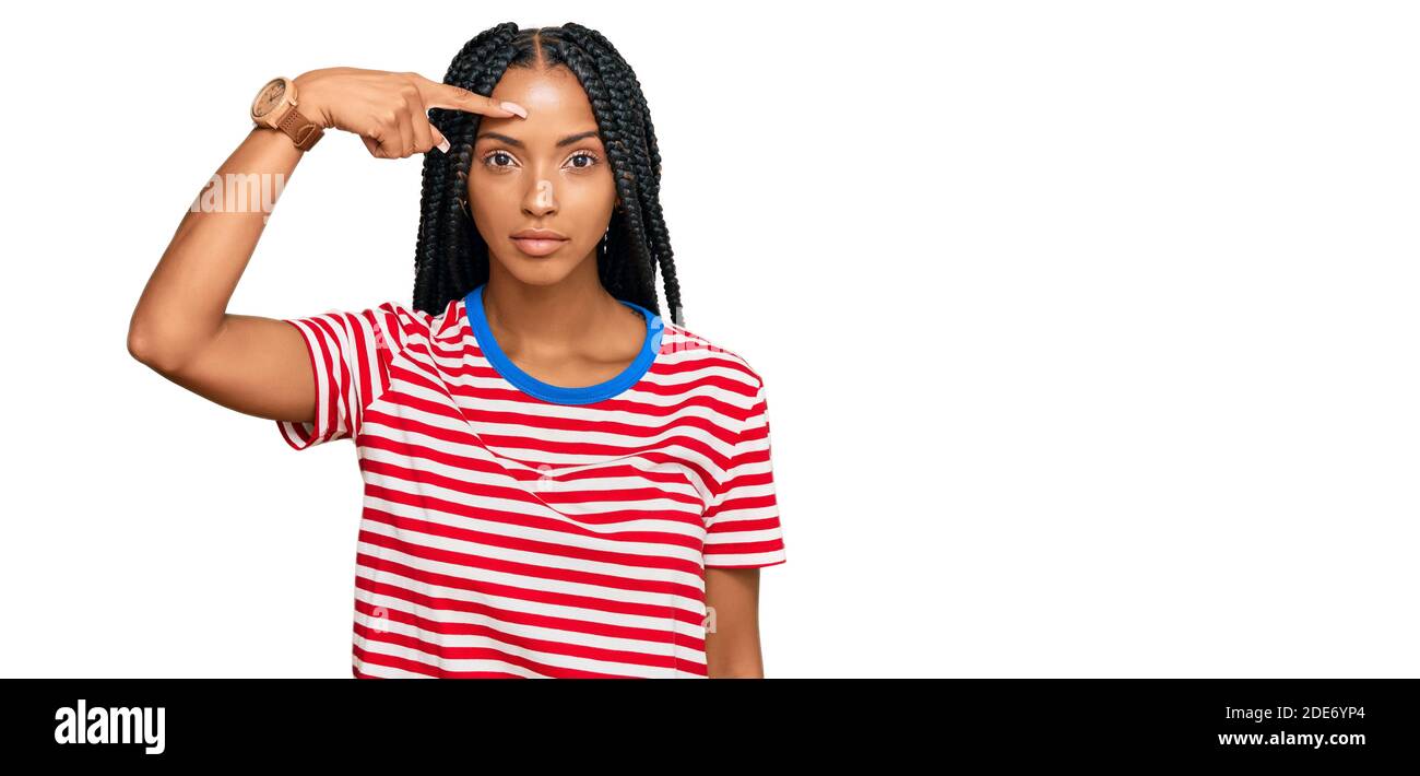 Beautiful hispanic woman wearing casual clothes pointing unhappy to ...