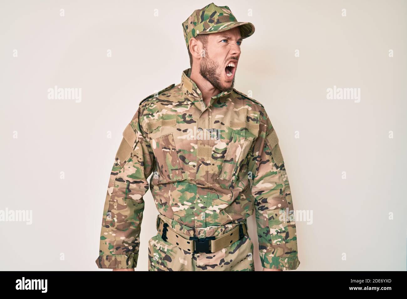 Young caucasian man wearing camouflage army uniform angry and mad ...