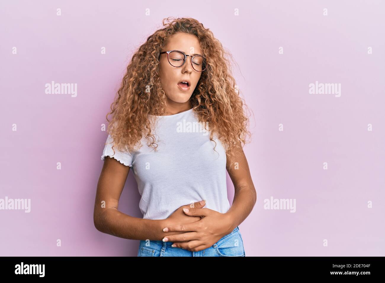 Beautiful caucasian teenager girl wearing white t-shirt over pink ...
