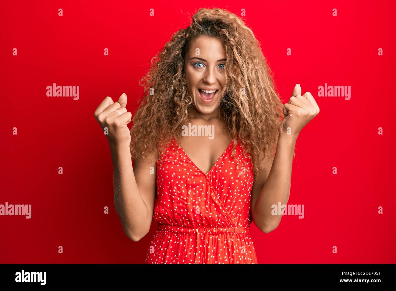 Beautiful caucasian teenager girl wearing summer dress screaming proud ...