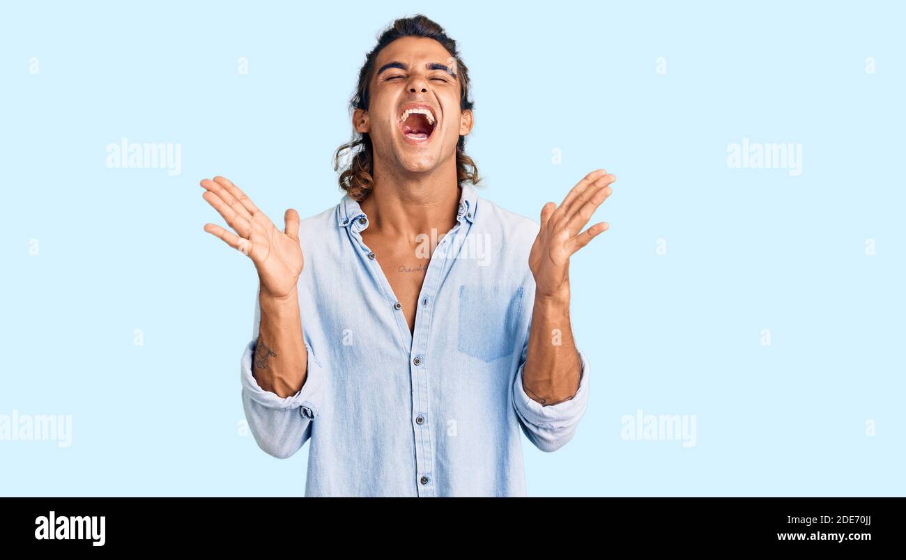 Young hispanic man wearing summer style celebrating mad and crazy for ...
