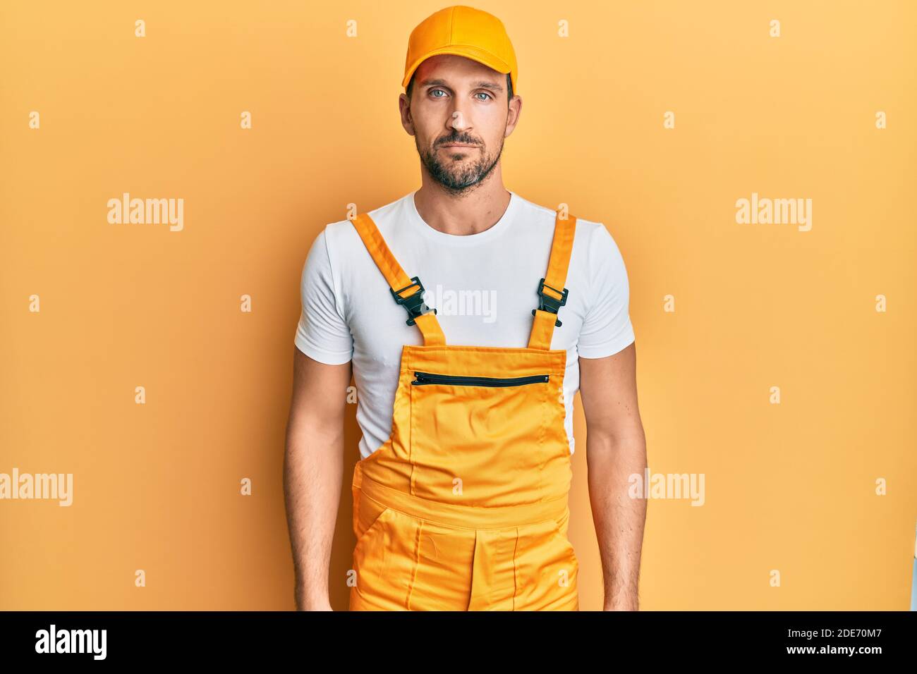 Tired handyman in yellow hi-res stock photography and images - Alamy