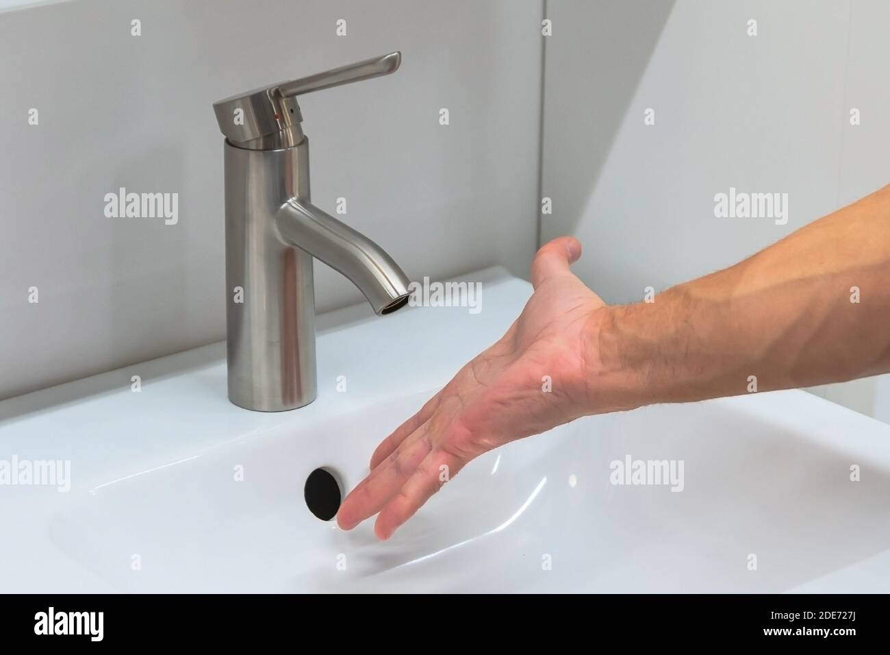 a man's hand opens the tap and the water doesn't flow Stock Photo - Alamy