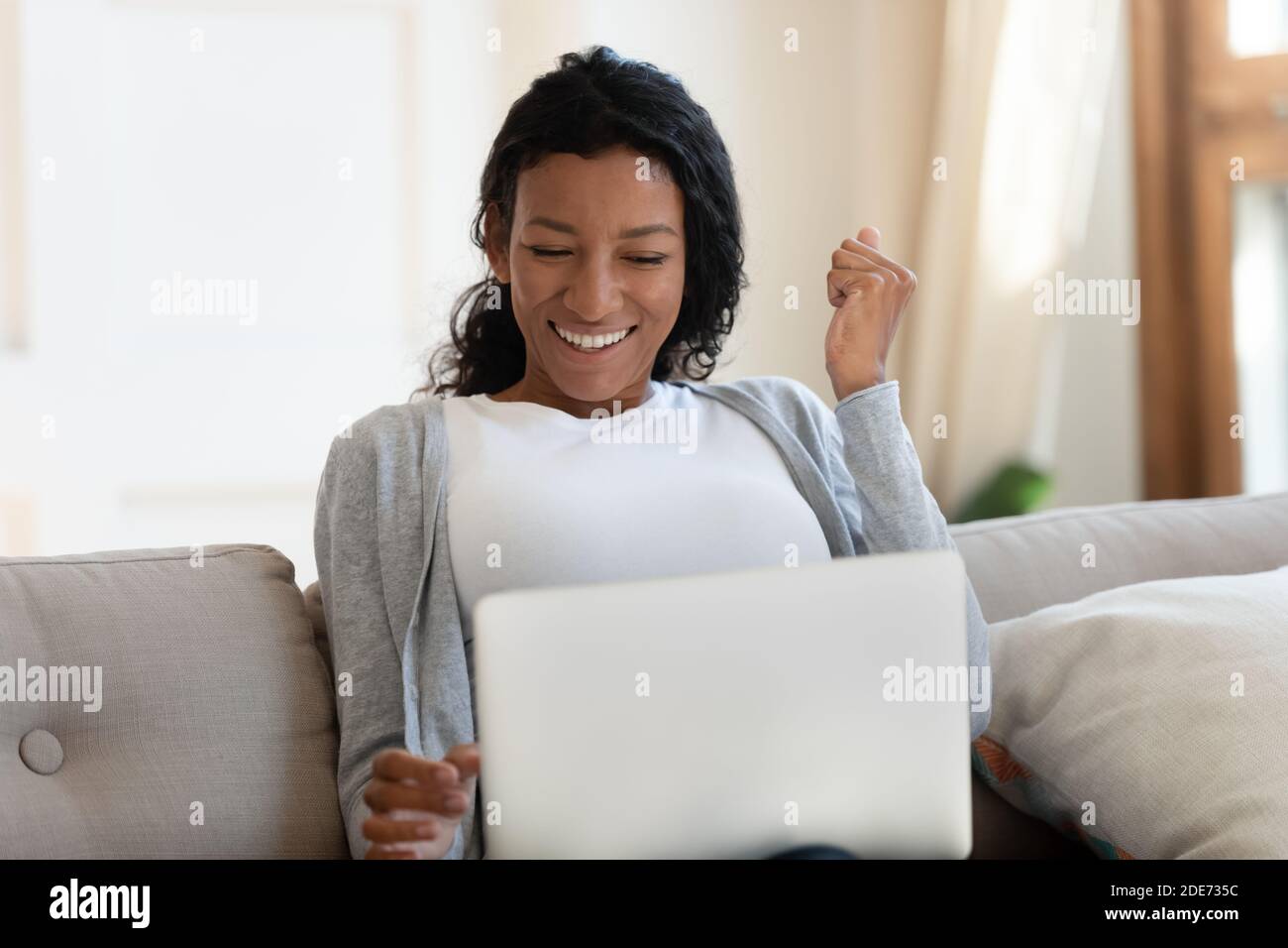 Excited African American woman triumph win lottery on computer Stock ...