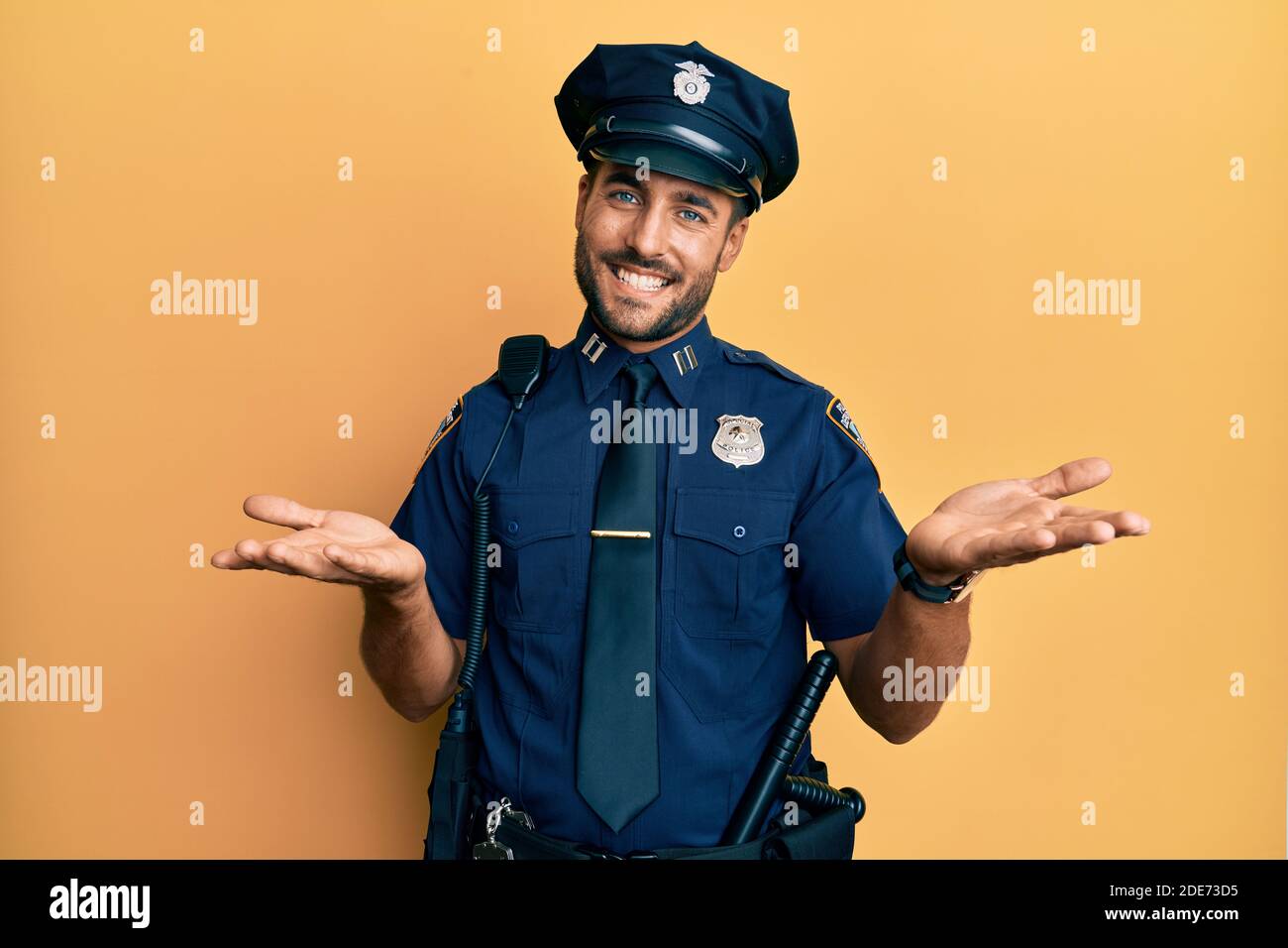 Handsome hispanic man wearing police uniform smiling cheerful offering ...