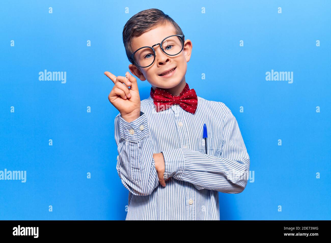 Cute blond kid wearing nerd bow tie and glasses with a big smile on ...