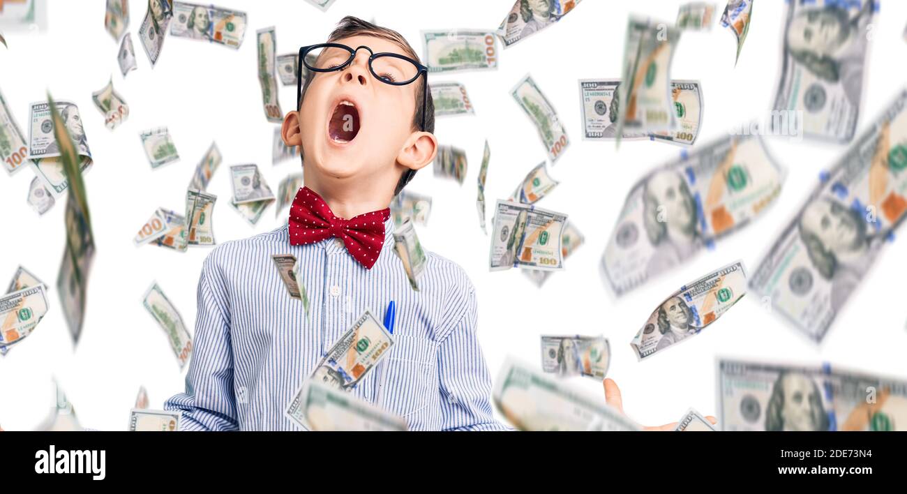 Cute blond kid wearing nerd bow tie and glasses crazy and mad shouting ...