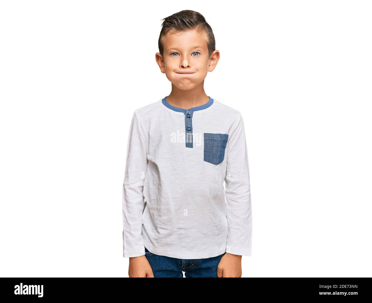 Adorable caucasian kid wearing casual clothes puffing cheeks with funny ...