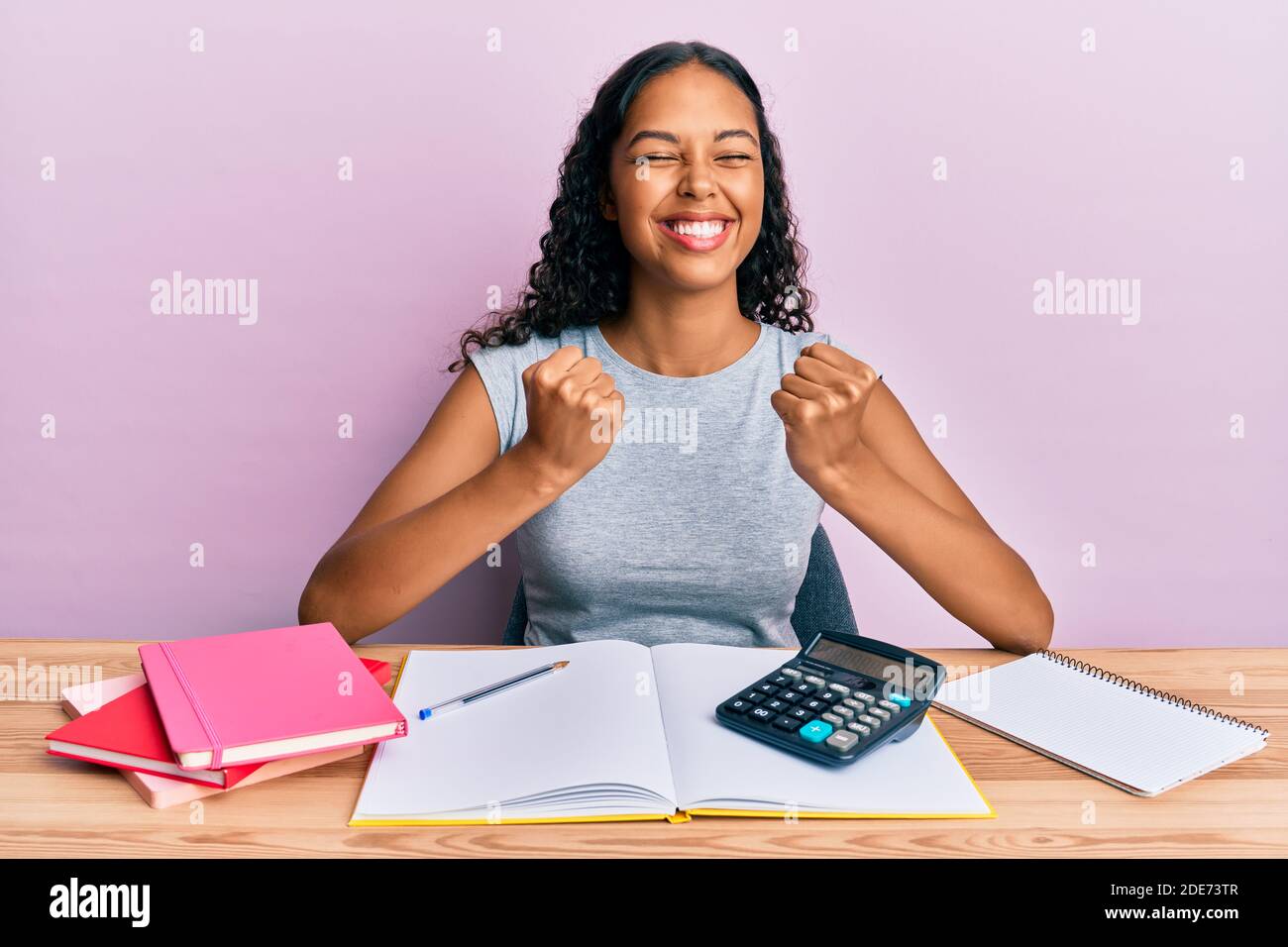 Young african american girl accountant working at the office excited ...