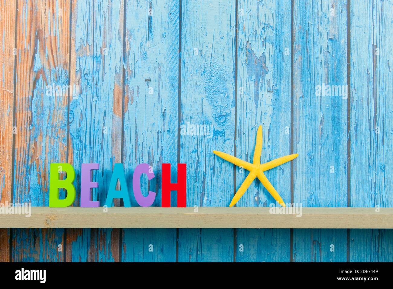 Blue wooden background with beach text Stock Photo - Alamy