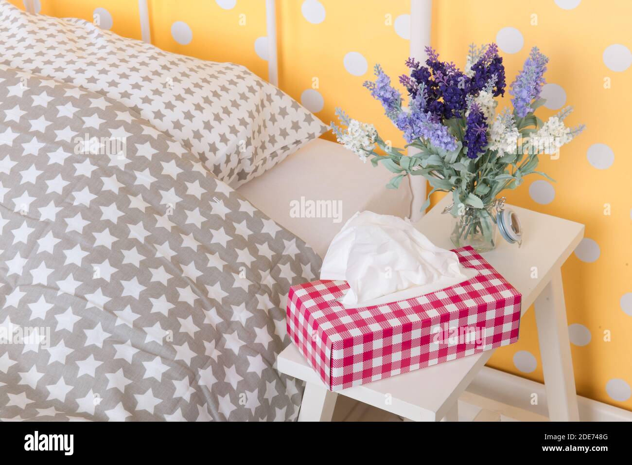 Bedroom with tissues and flowers Stock Photo - Alamy