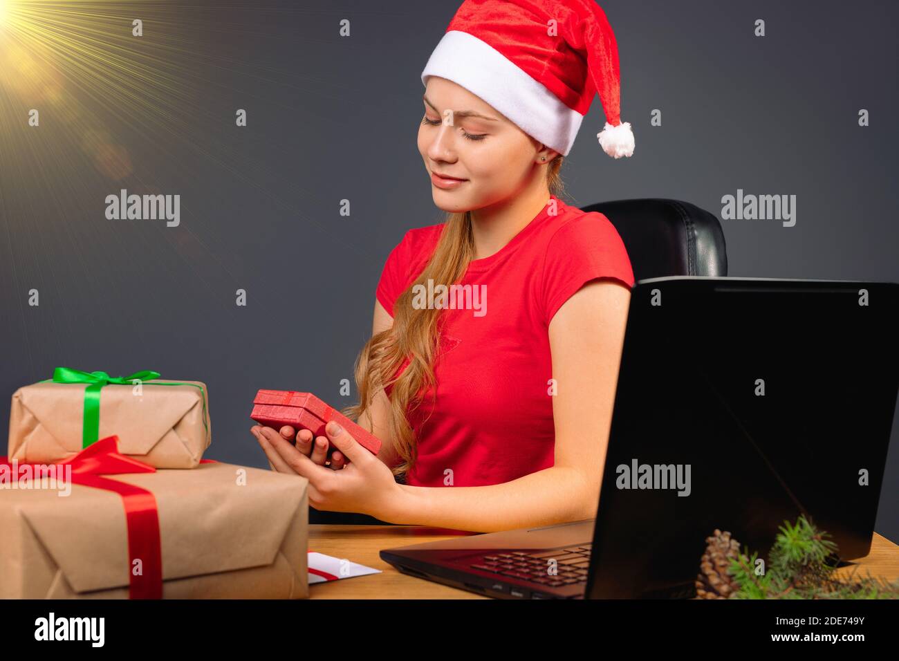 Elf girl at the computer. The elven girl looks at a small gift. Gray ...