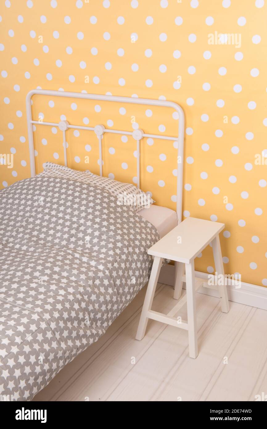 Yellow Bedroom with single bed Stock Photo - Alamy