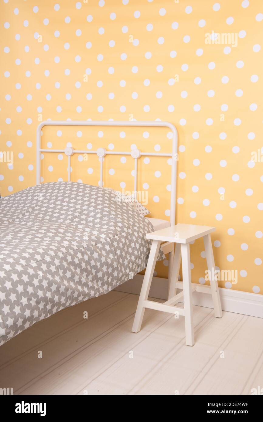 Yellow Bedroom with single bed Stock Photo - Alamy