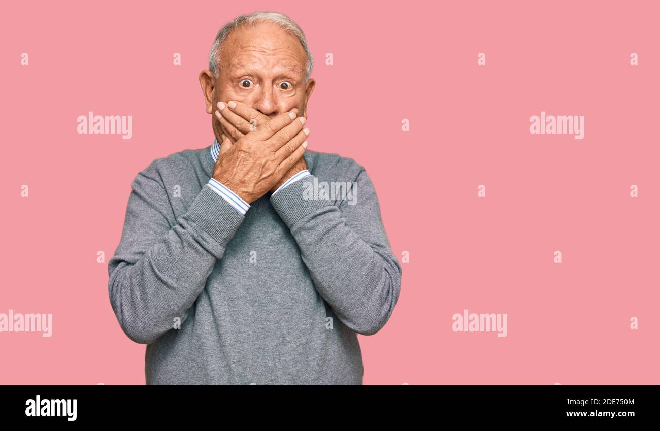 Senior caucasian man wearing casual clothes shocked covering mouth with ...